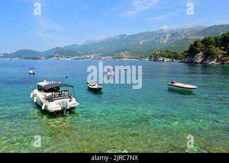 Boats moored in Sveti Stefan Bay, Montenegro Stock Photo - Alamy