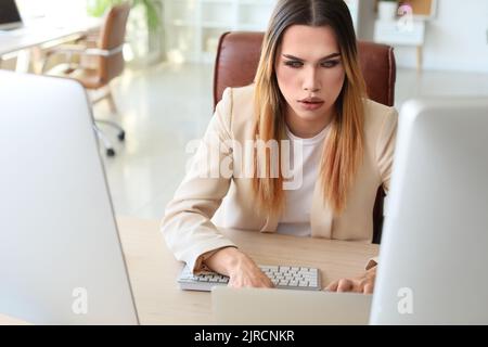 Transgender programmer working in office Stock Photo - Alamy