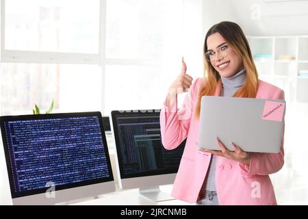 Transgender programmer with laptop showing thumb-up on blue background ...