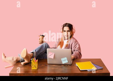 Transgender programmer with laptop at table on pink background Stock ...
