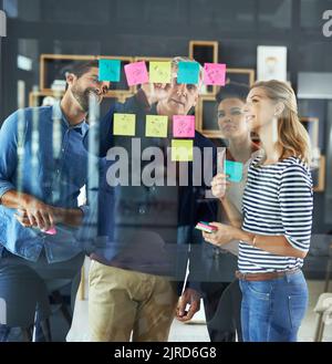 Having a productive brainstorming session. a group of young designers ...