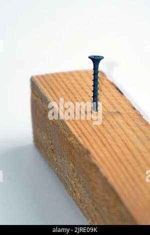 A black screw twisted into a wooden board Stock Photo - Alamy