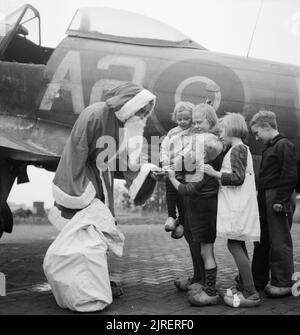 Leading Aircraftman Fred Fazan dressed as Santa Claus hands out ...