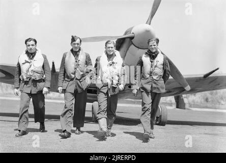 Pilots of No. 611 Squadron walk away from a Supermarine Spitfire Mk V ...