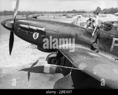 An air gunner of No. 264 Squadron RAF about to enter the gun turret of ...