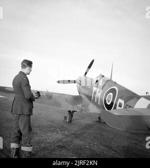 An engine fitter watches the CO of No. 504 Squadron, Squadron Leader R ...