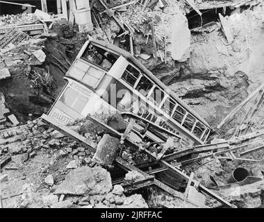 A bus lies in a crater in Balham, south London, following a night-time ...