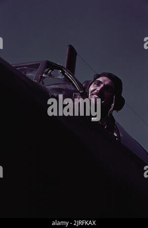 The Canadian pilot of a Vickers Wellington bomber looks out from his ...
