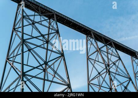 A tall train bridge viaduct engineered with iron steel trusses and ...