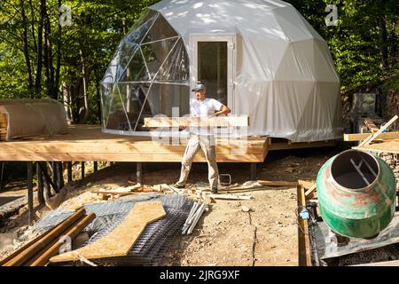 the master builds the dome. Outside spherical glamping dome ...
