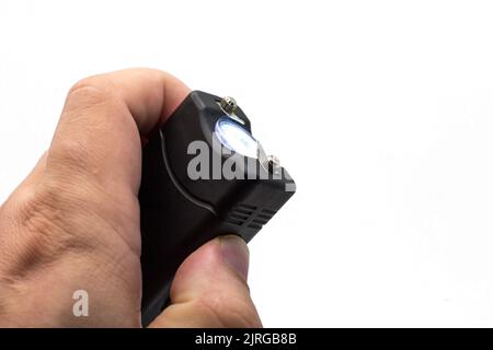 Taser in a man's hand, close-up, isolated white background Stock Photo ...