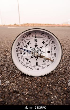 Travel Concept Compass on the Asphlat Road Stock Photo - Alamy