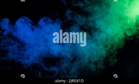 Green-blue smoke in neon light on black background Stock Photo - Alamy