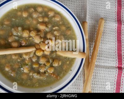 Chickpea soup with bread sticks Stock Photo - Alamy