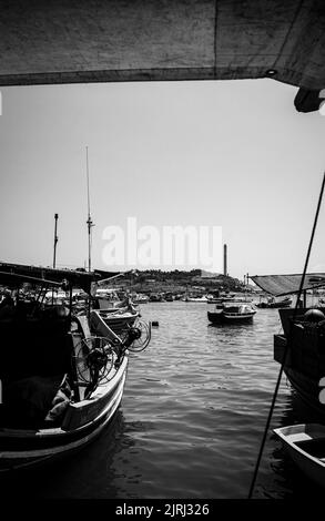 A grayscale shot of the sea with boats Stock Photo - Alamy
