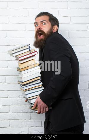 Funny teacher or professor with book stack. Thinking serious mature ...