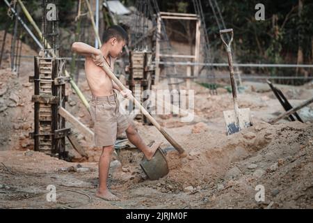 Poor children at the construction site were forced to work. Concept ...