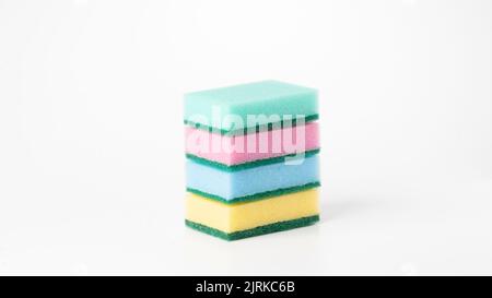 Multicolored four sponges folded into a flat stack on a white ...
