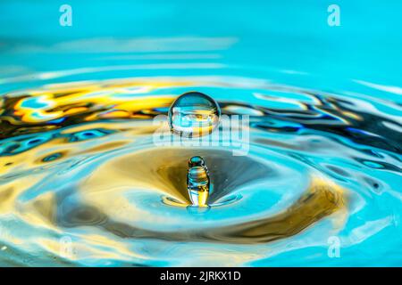A water drop ripple on turquoise background Stock Photo - Alamy