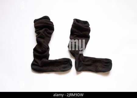 long brown dirty socks on a white background, old women's knee socks ...