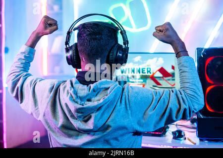 shoulder shot of professional gamer playing live video game on green ...