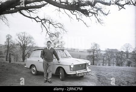 1958, historical, outside in the countryside, beside a field, an Austin ...