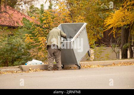 Garbage man with trash can on head Stock Photo - Alamy