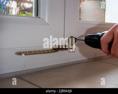 installation of a window stop, drilling holes for screws in plastic ...