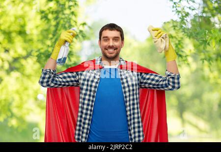 smiling man in superhero cape with rag and cleaner Stock Photo - Alamy