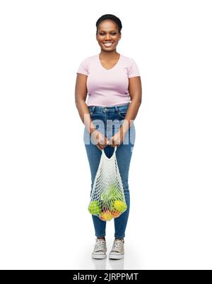 african woman with food in reusable string bag Stock Photo - Alamy
