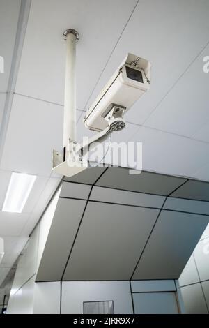 CCTV camera placed high on the ceiling of a city subway station Stock ...