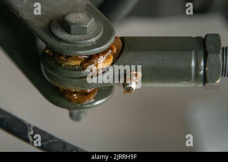 Grease nipple on industrial equipment with excessive grease lubricant ...