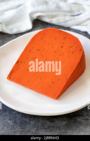 Red gouda cheese. Guoda cheese with sun-dried tomatoes and basil on a ...