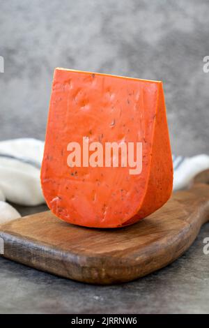 Round gouda cheese. Dark background Stock Photo - Alamy