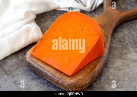 Red gouda cheese. Guoda cheese with sun-dried tomatoes and basil on a ...