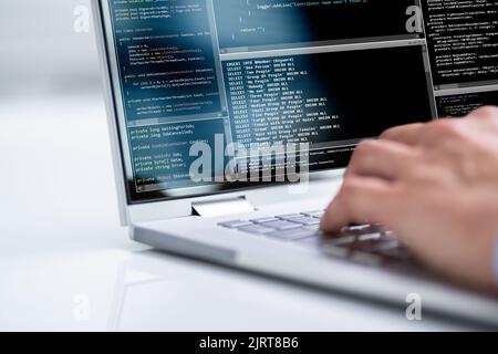 Computer Programmer Using Development Software On Laptop Stock Photo ...