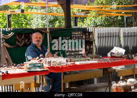Man with mustache sells vintage jewelry on the flea market in Georgia ...