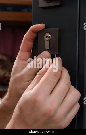 Hex key and installation of door lock and handle, close-up installation ...