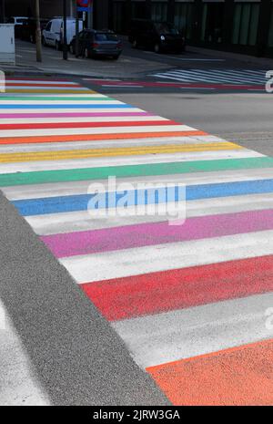 pedestrian crossing with many colors on the asphalted road Stock Photo ...