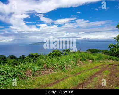 Cliffside overlook from a lush, tropical viewpoint shows the beautiful ...