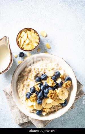 Oatmeal porrige in craft bowl at white background Stock Photo - Alamy