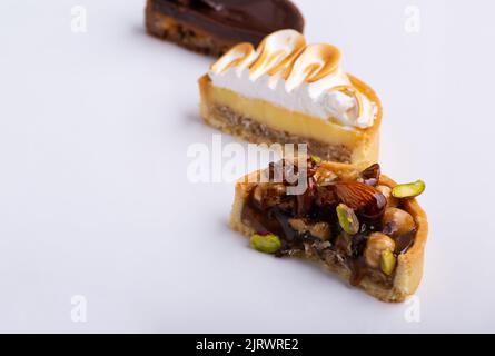 A Three pieces of cakes cut in half isolated on a white background ...