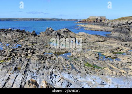 Rocky outcrop and Thorne island, West Angle Bay, Pembrokeshire, Wales ...