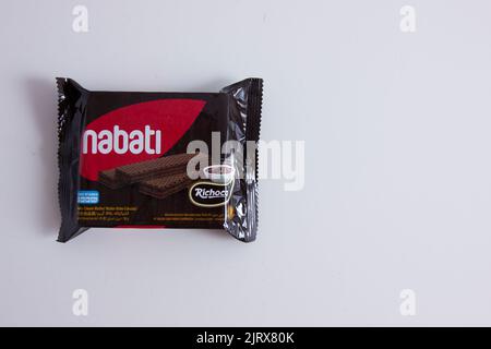 A closeup of a chocolate Nabati wafer bar on a white table background ...