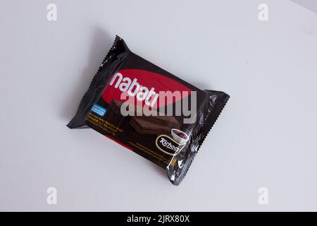 A closeup of a chocolate Nabati wafer bar on a white table background ...