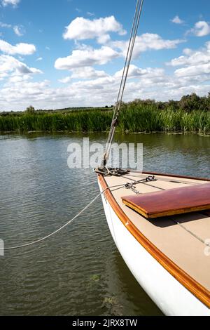 The front end or bow of a traditional sailing boat moored against the ...