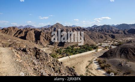 Wadi Shawka Dam panorama, with empty dam, dry riverbed and rocky Hajar ...