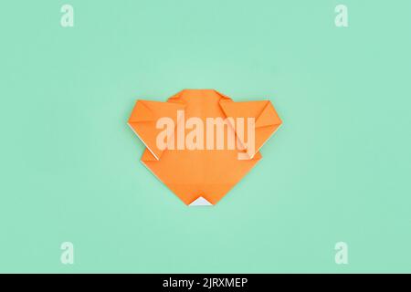 Origami Bear. Step-by-step photo instruction on a green background. DIY ...