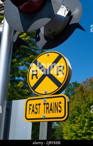 Railroad crossing sign with brilliant blue skies in the background ...