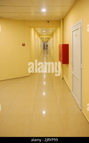 A long bright yellow hallway Stock Photo - Alamy
